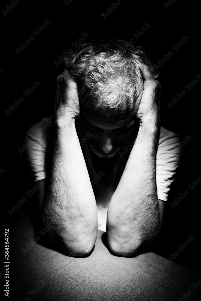 Male person, frustrated, angry, mental health troubles, alone at table ...