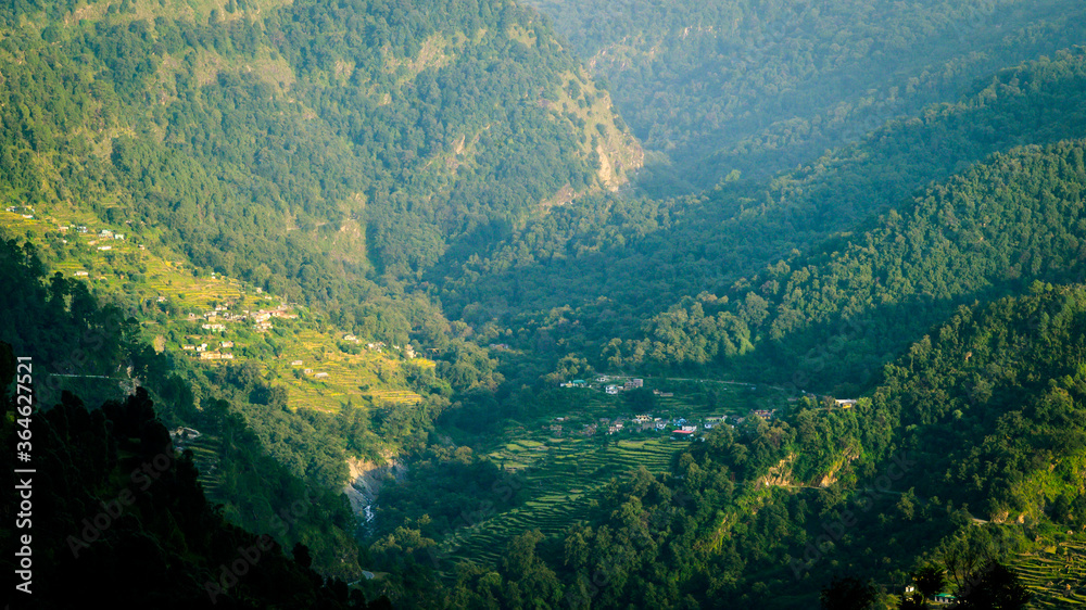 Scenic North Indian villages in Himalaya, surrounded by hills, dense ...
