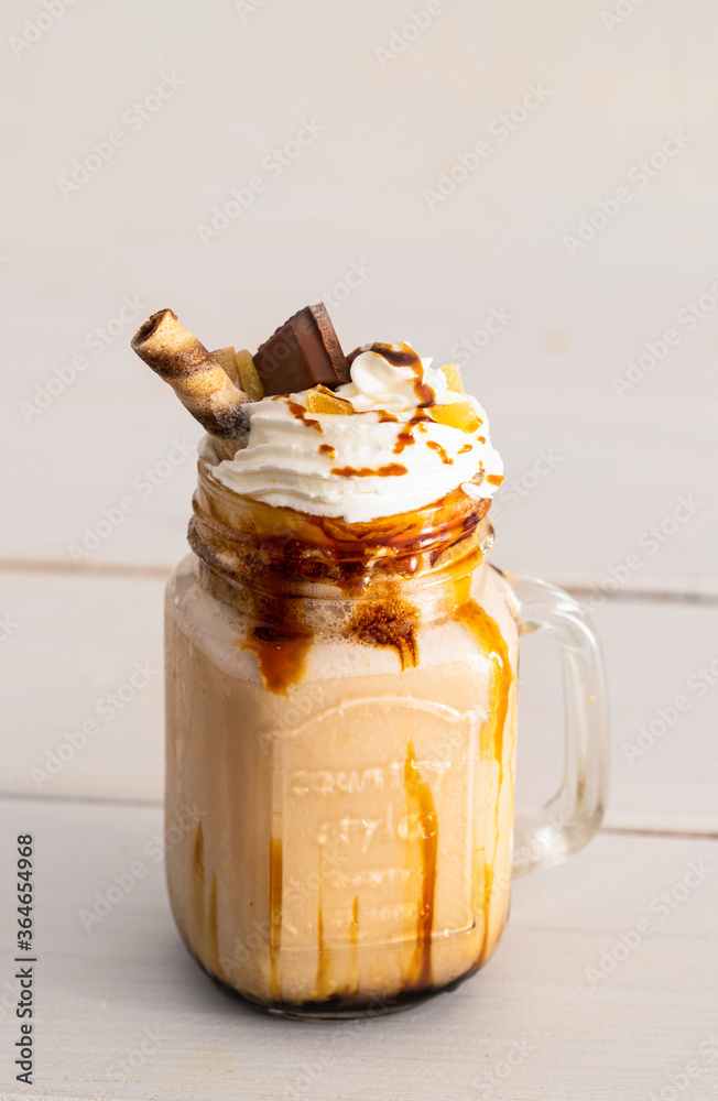 Milkshake mason jar with whipped cream and caramel decorated with ...