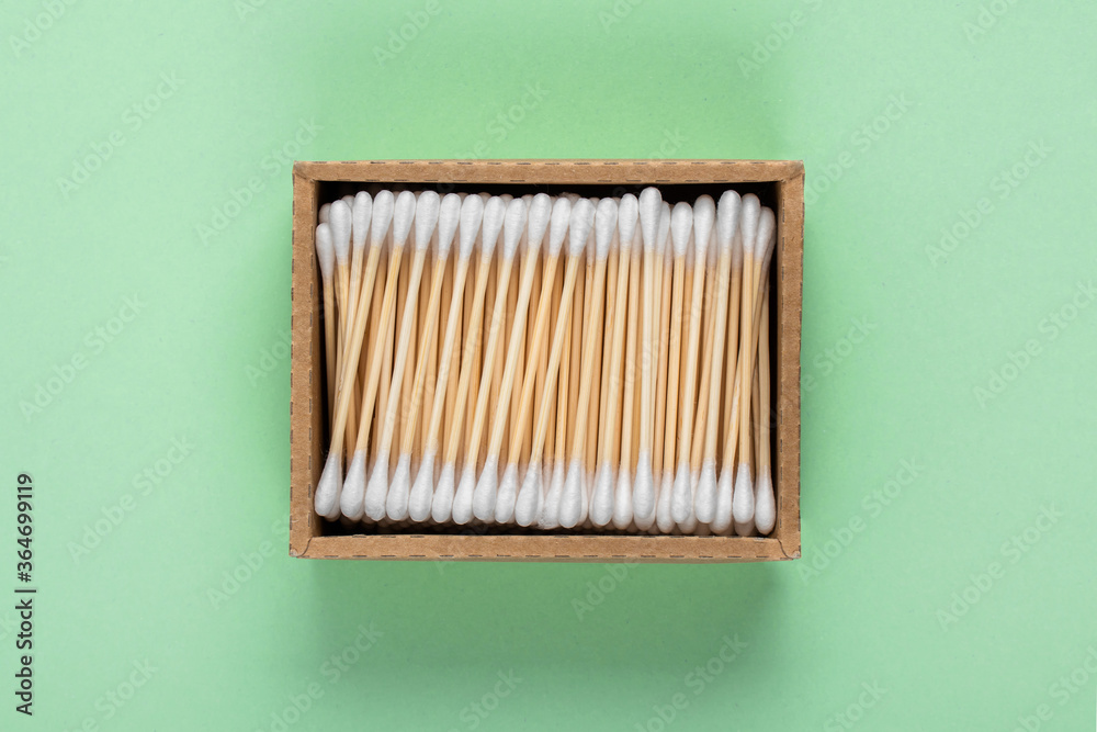 Eco natural bamboo ear sticks in a craft box on a green background ...