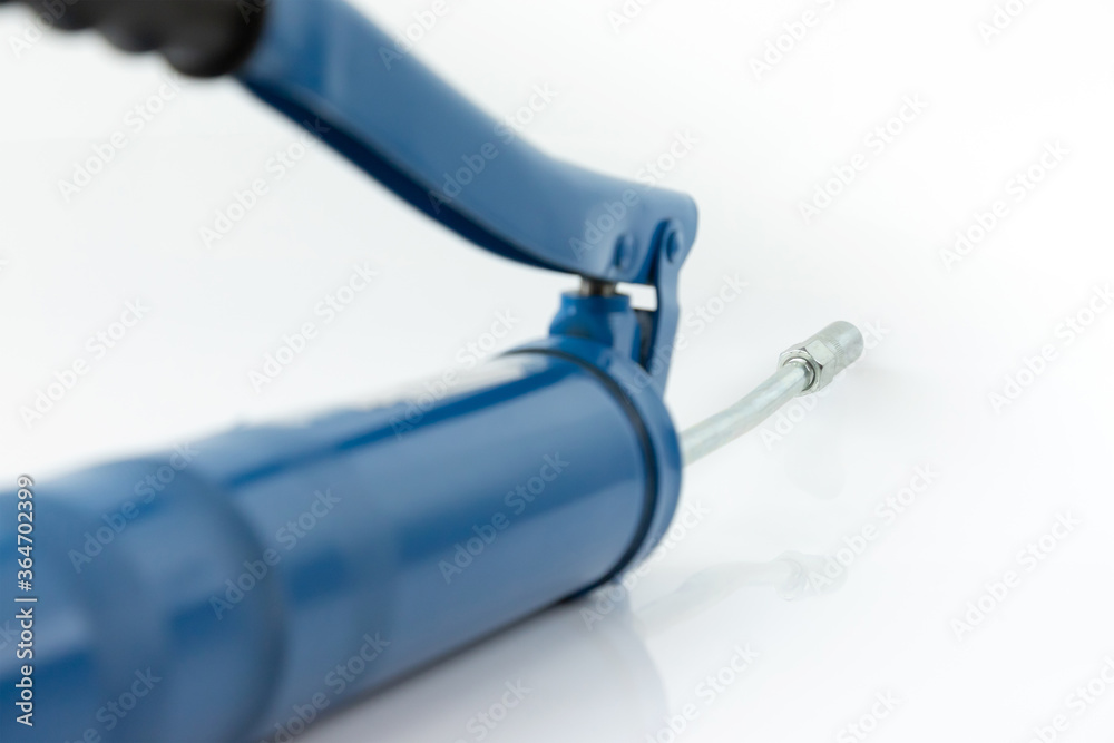 steel spout of blue grease gun on white background. Stock Photo | Adobe ...