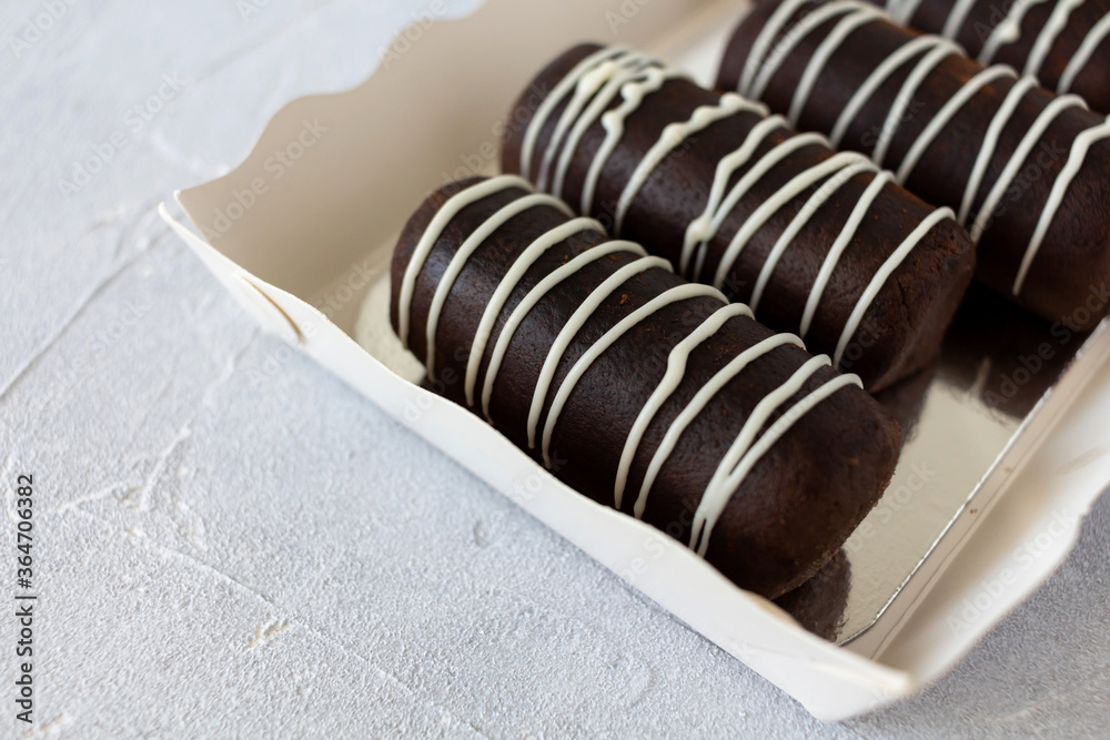 Chocolate rum balls cake decorated with white glaze on paper substrate ...