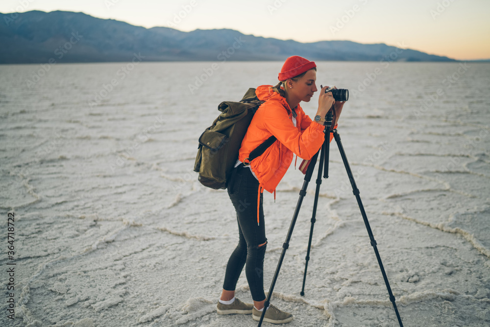 Professional female journalist shooting film in wild environment of ...