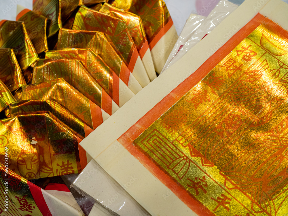 Gold Chinese joss paper folded into the shape of a gold ingot for ...