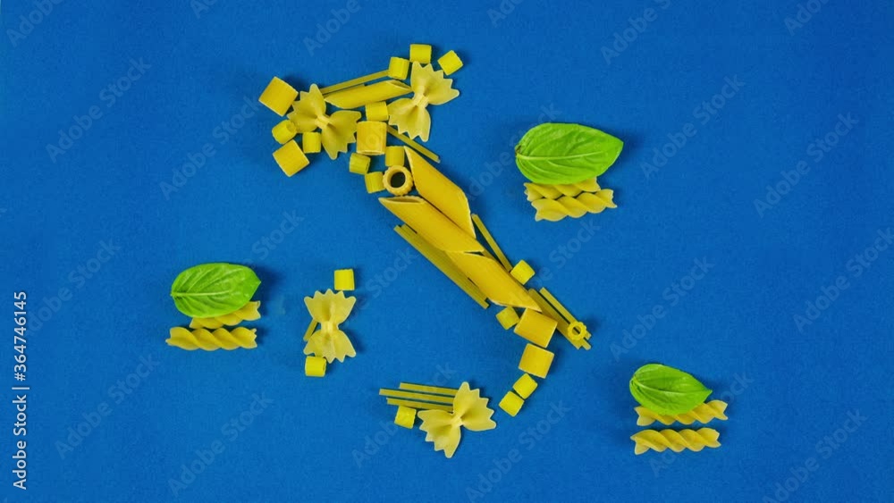 Map of Italy made of raw pasta. Small boats made of basil leaves move ...