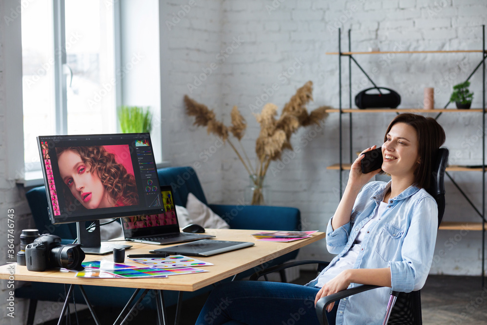 Portrait of graphic designer working in office with laptop,monitor ...