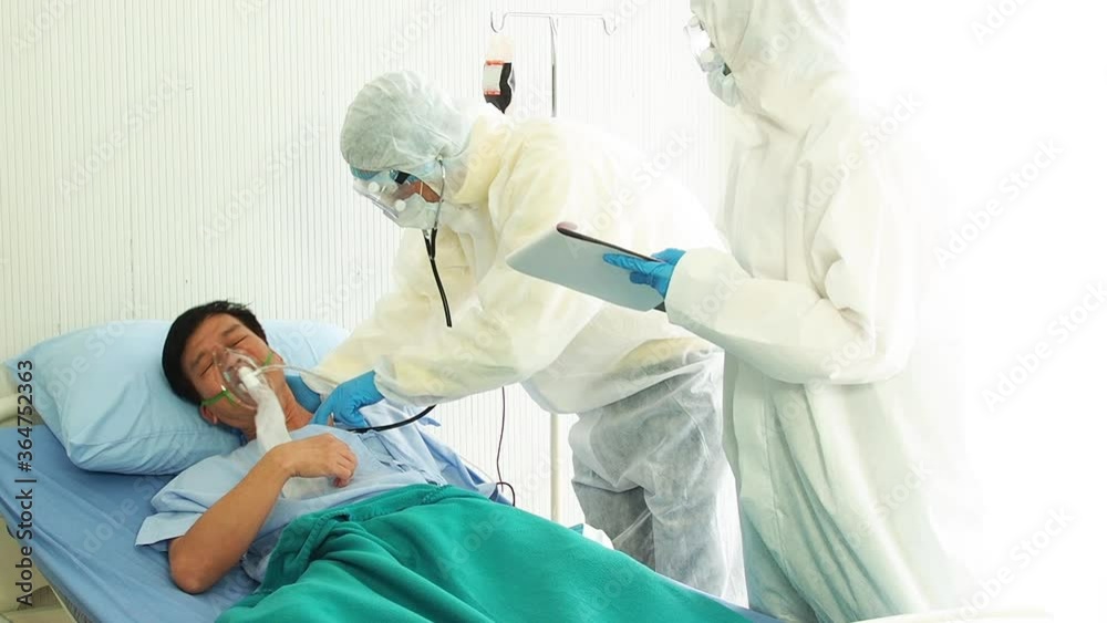 The doctor takes care a sick patient, coughing from coronavirus on ...