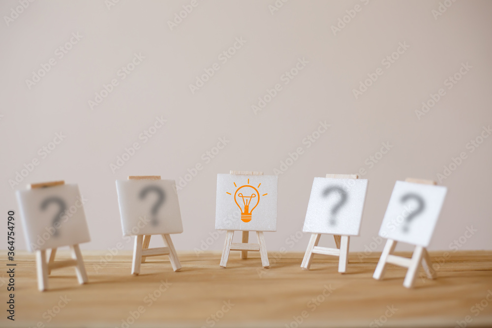 Outstanding sign stand with a light bulb icon and question mark symbol ...