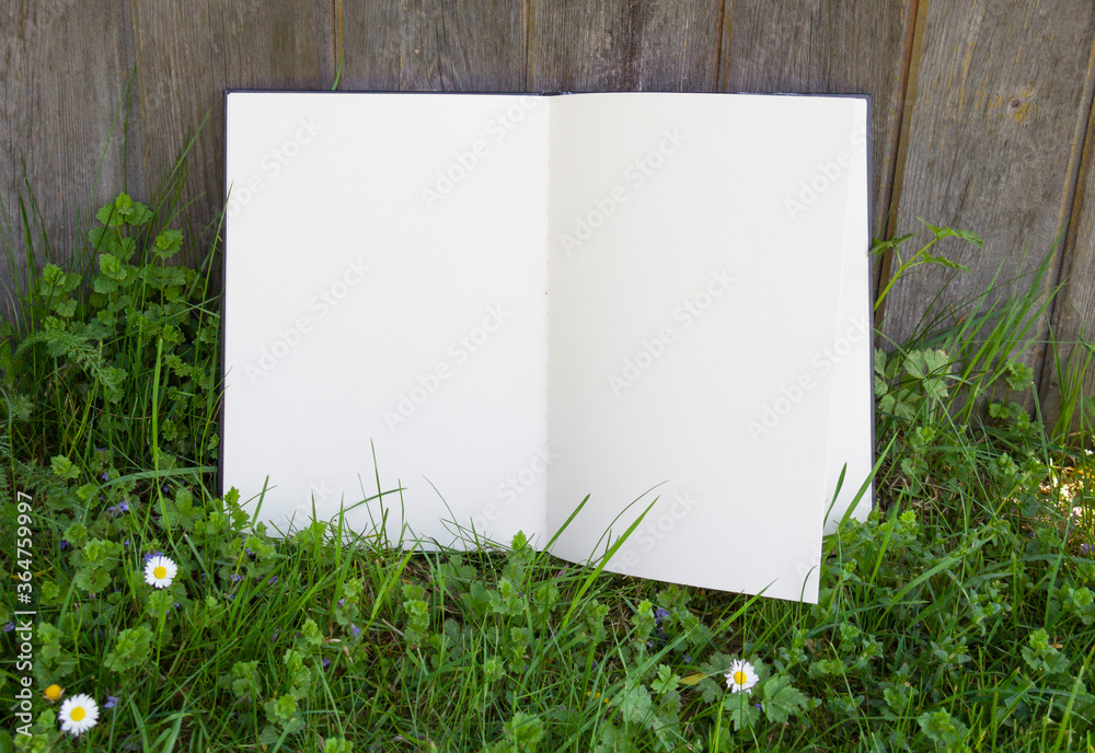 Notebook mockup with gray wooden wall background, green grass, mock up ...