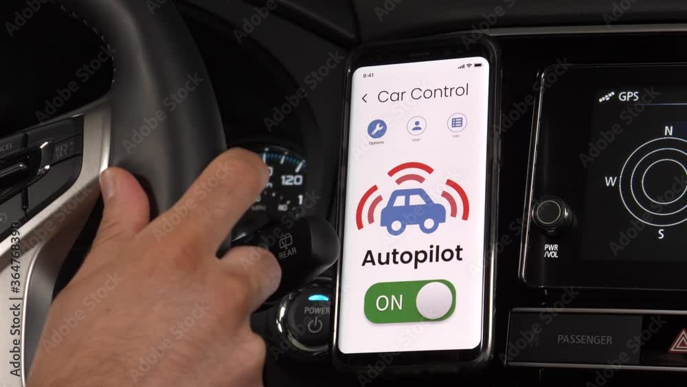 Driver of a car activating the autopilot of the vehicle using the ...