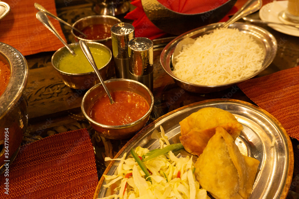 Traditional Indian food at the restaurant. Samosa with cabbage salad ...