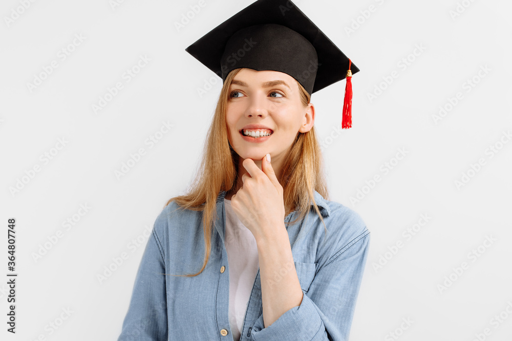 pensive, dreamy graduate with a graduation cap on her head, pensive ...