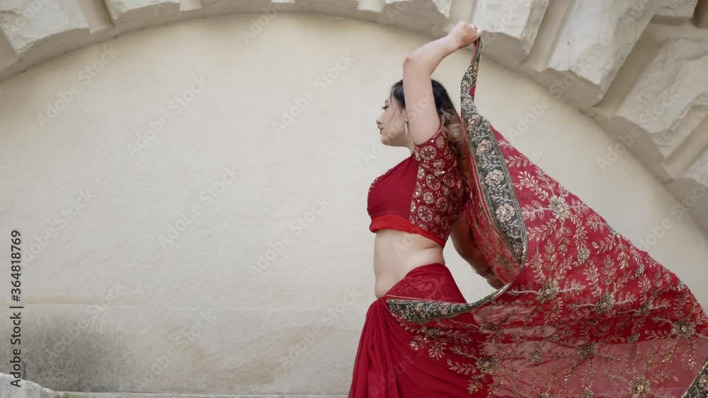 Indian woman dance on streets of ancient architecture city of India ...