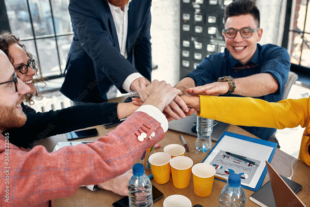 Group of joyful smiling happy people celebrate win with arms up ...