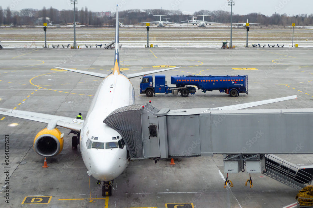 Air plane with passenger boarding bridgennector and gas tank carries ...