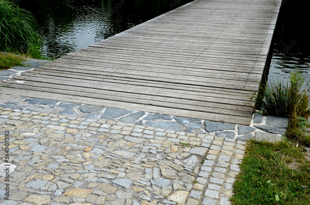 wooden wide pedestrian bridge over the river pond lake, without ...