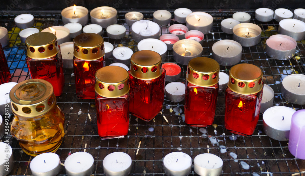Church candles and lamps for the repose in a catholic church. Christian ...