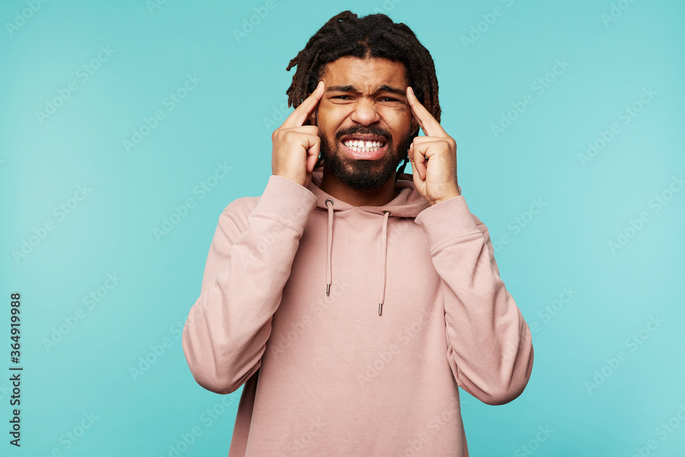 Indoor shor of young brown-eyed dark haired male with dreadlocks ...