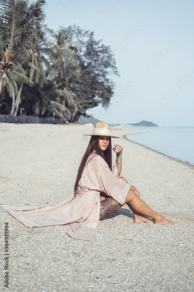 Beautiful young woman posing on the beach swim suit.Happy smiling girl ...