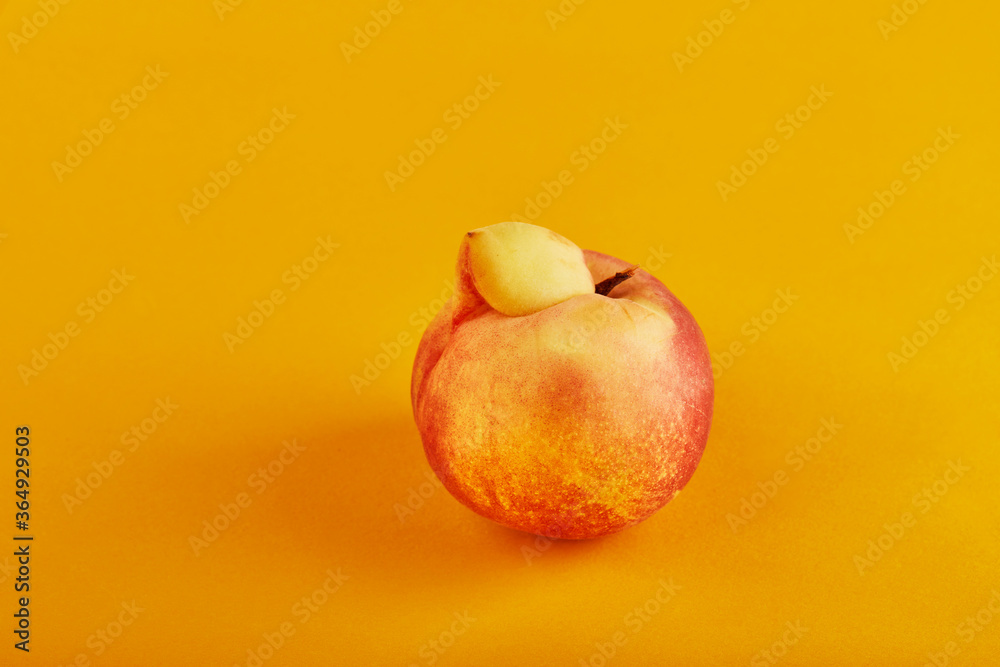 An ugly fruit or vegetable. Very ugly peach mutant on an orange ...