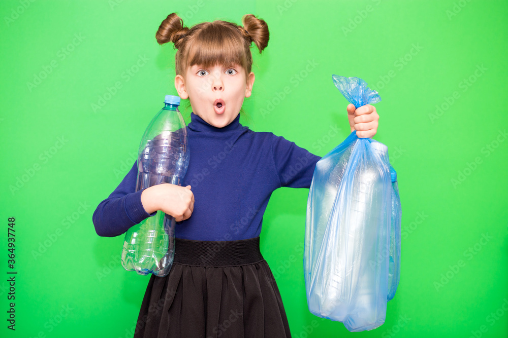 Girl hold trash bag and plastic bottle and shows interest in ...