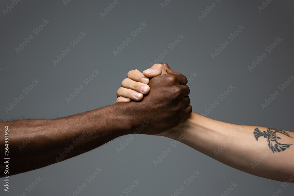 Teamwork. Racial tolerance. Respect social unity. African and caucasian ...