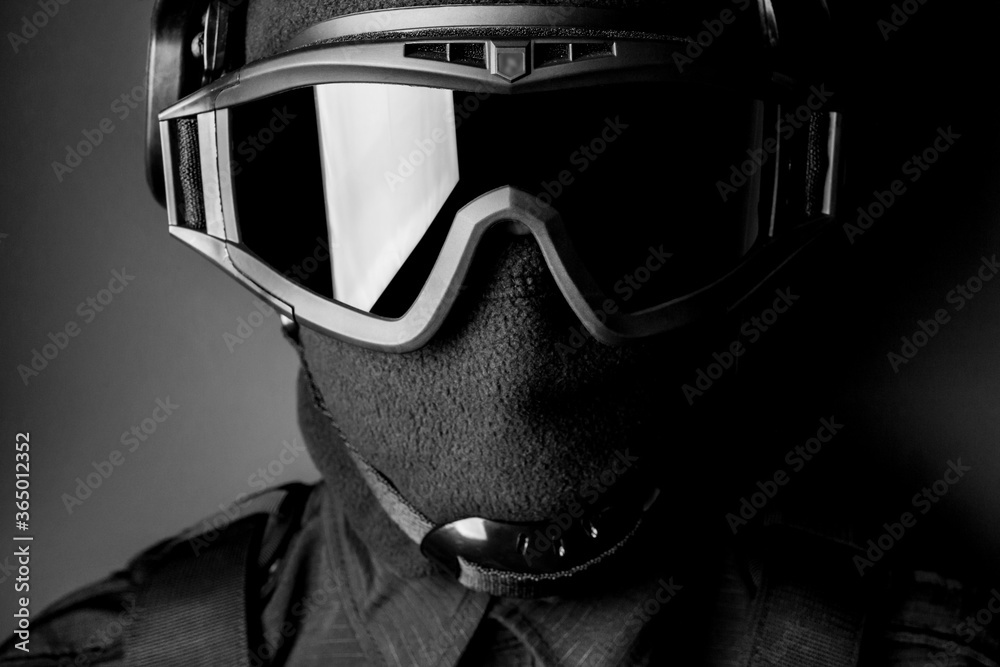 SWAT in black uniform, face mask and bulletproof vest. Tactical helmet ...