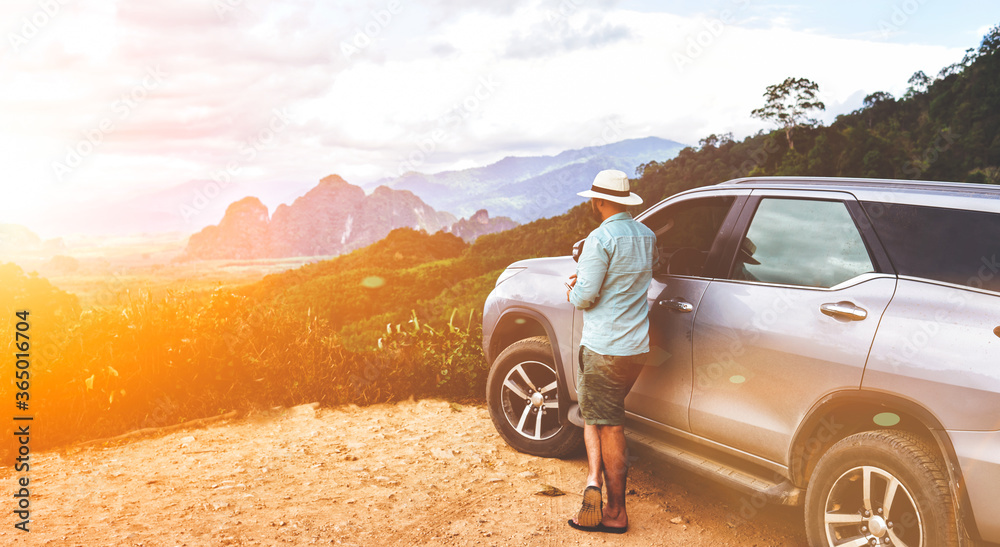 Back view of a young man wanderer is enjoying amazing jungle view ...