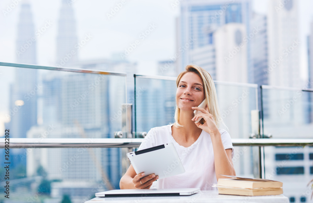 Attractive cheerful female journalist having phone conversation with ...