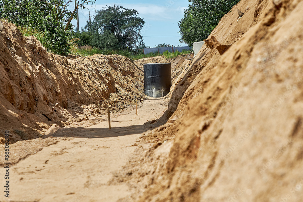 The trench for the laying and installation of water pipes with aligned ...