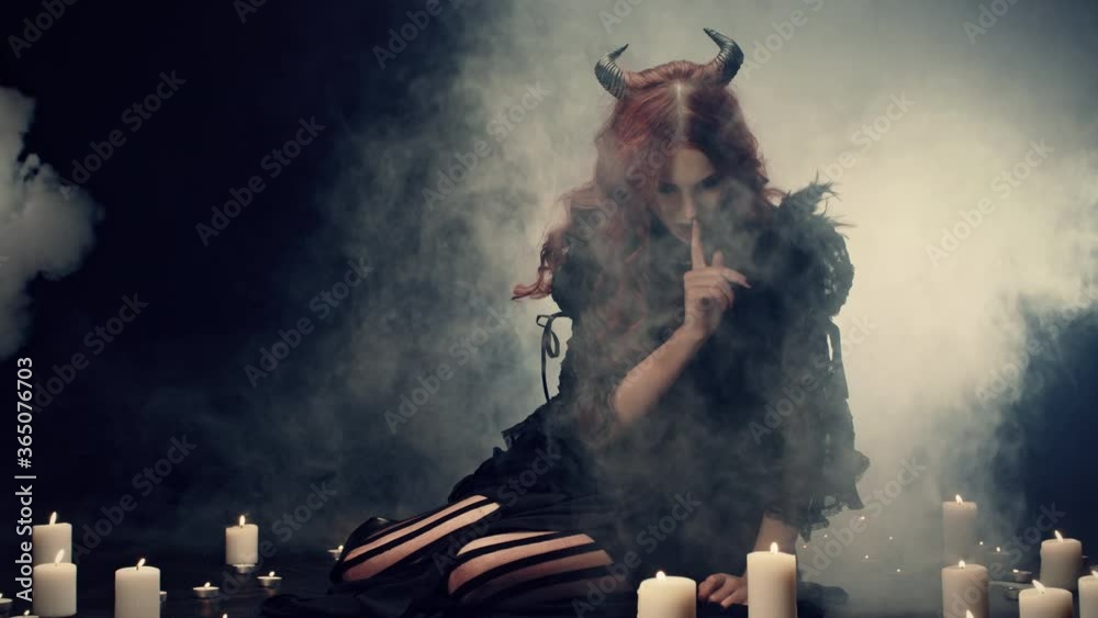 Woman dressing in dark casts, spelling, conducting ritual and summon ...