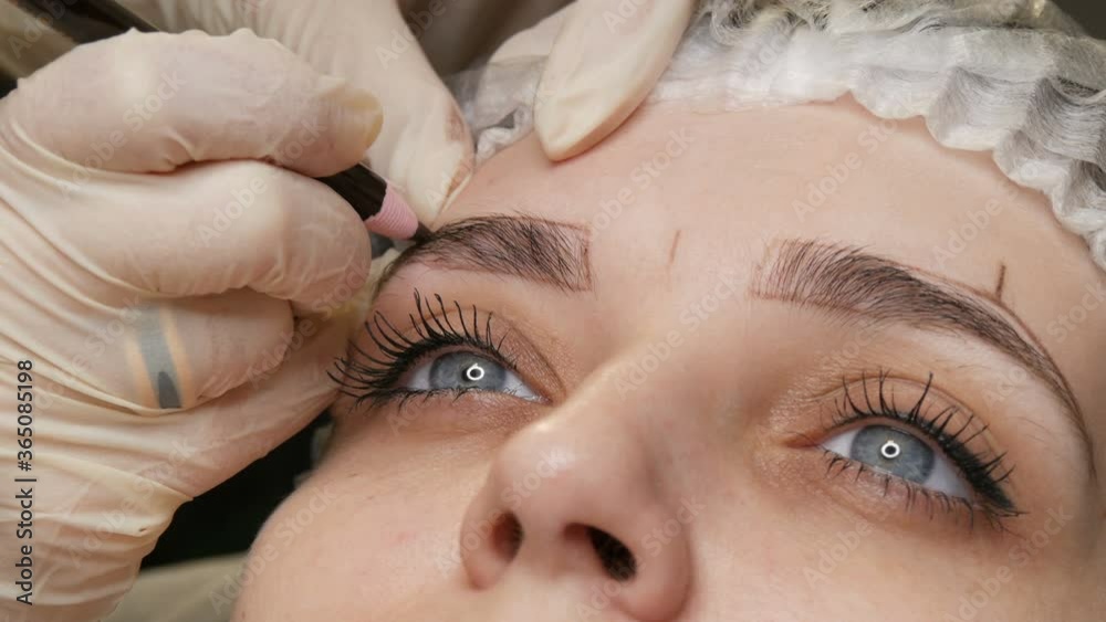 Vidéo Stock The microblading master corrects the new shape of the ...