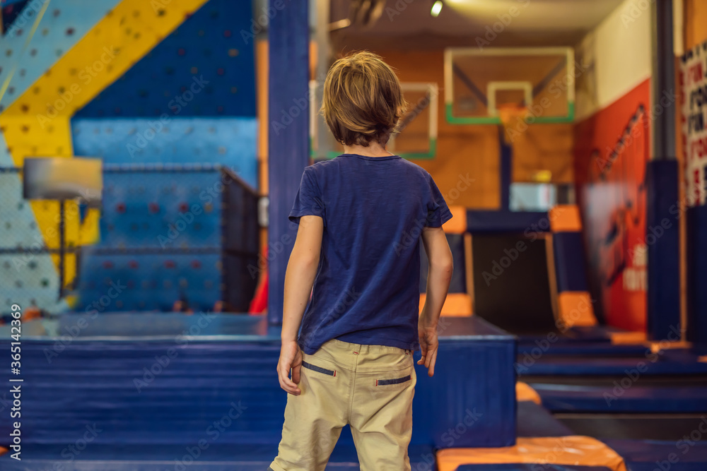 Cute boy jumping on trampoline in entertainment center Stock Photo ...