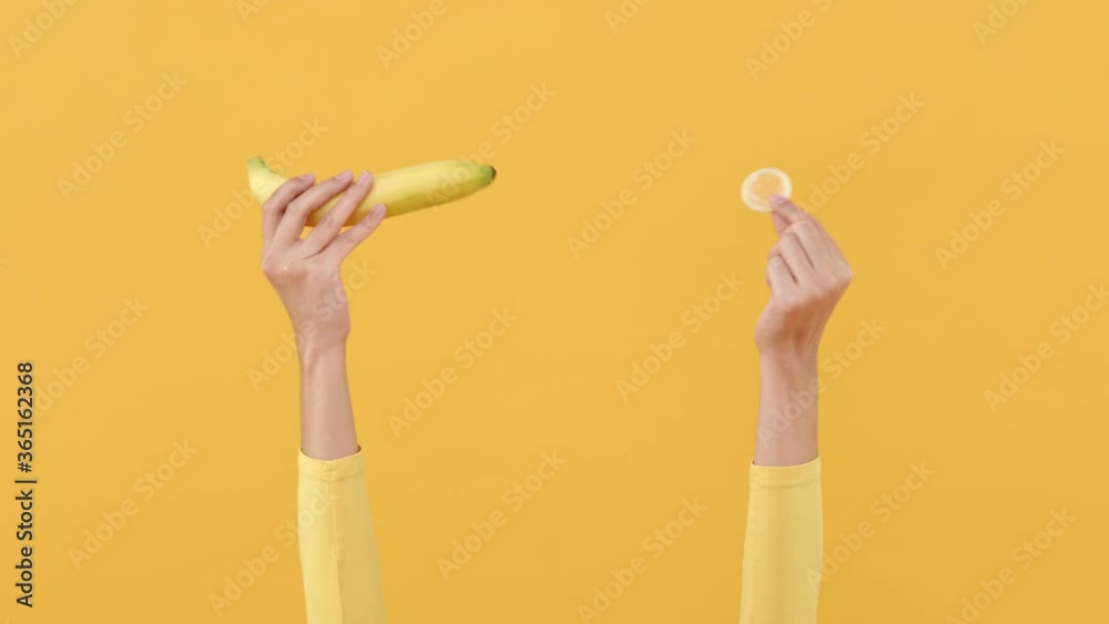 Woman Hands Showing Banana And Condom For Safe Sex And Contraceptive