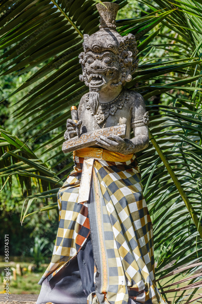 Statue of Sang Suratma god at Balinese Hindu Pura Dalem (Temple of the ...