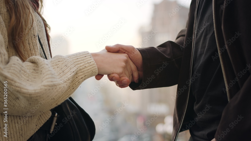 Unrecognizable couple handshaking outside. Closeup people hands holding ...