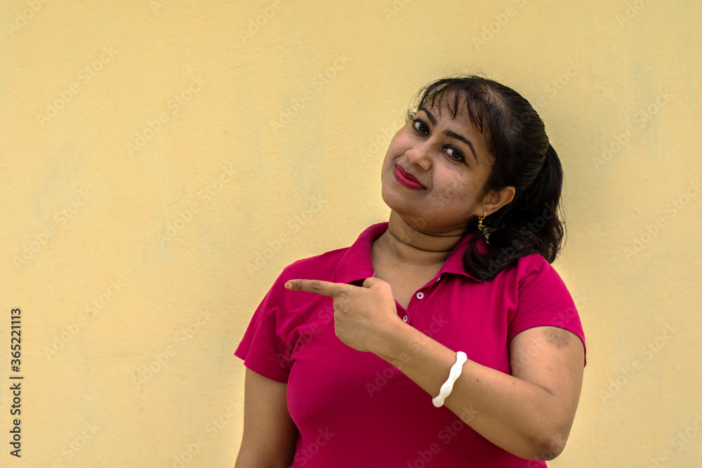 Indian female model looking straight happily with slight smiling face ...
