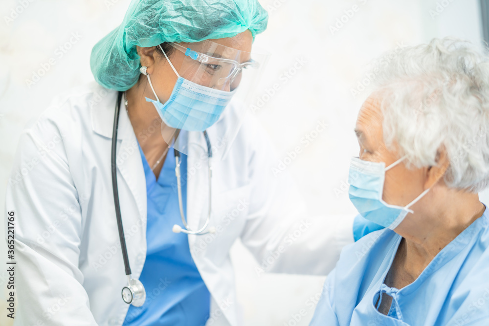 Asian doctor wearing face shield and PPE suit new normal to check ...