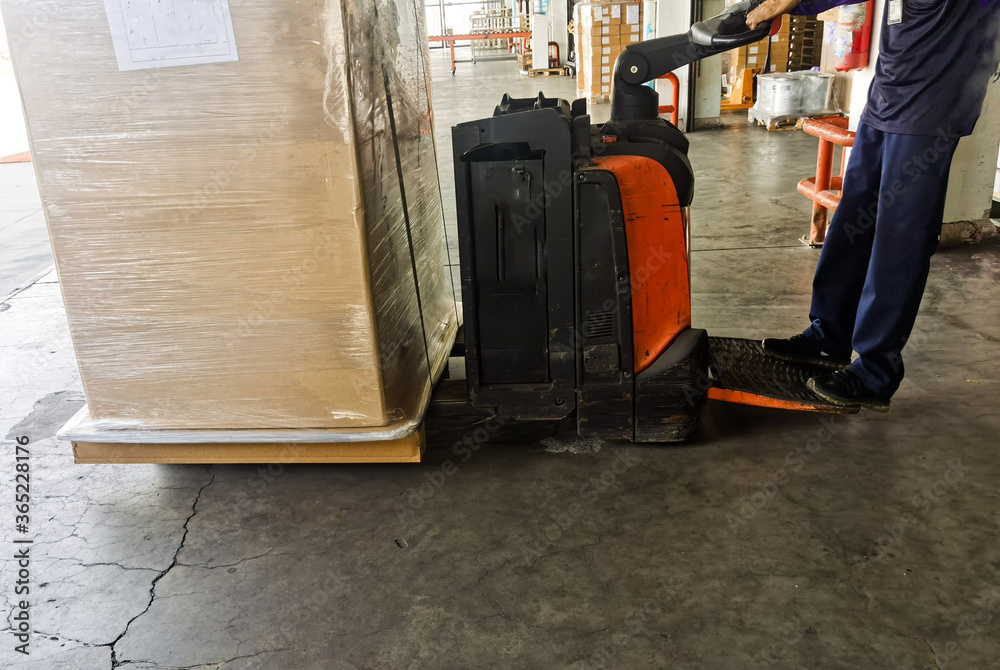 Worker driving forklift loading and unloading shipment carton boxes and ...