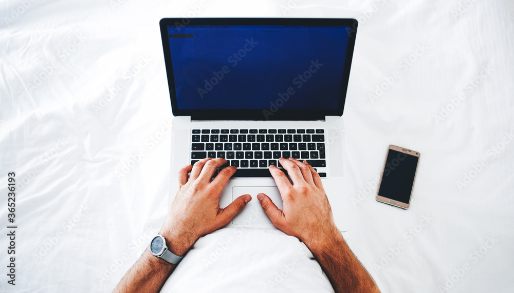 Top view of hipster guy is typing text message in social network via ...