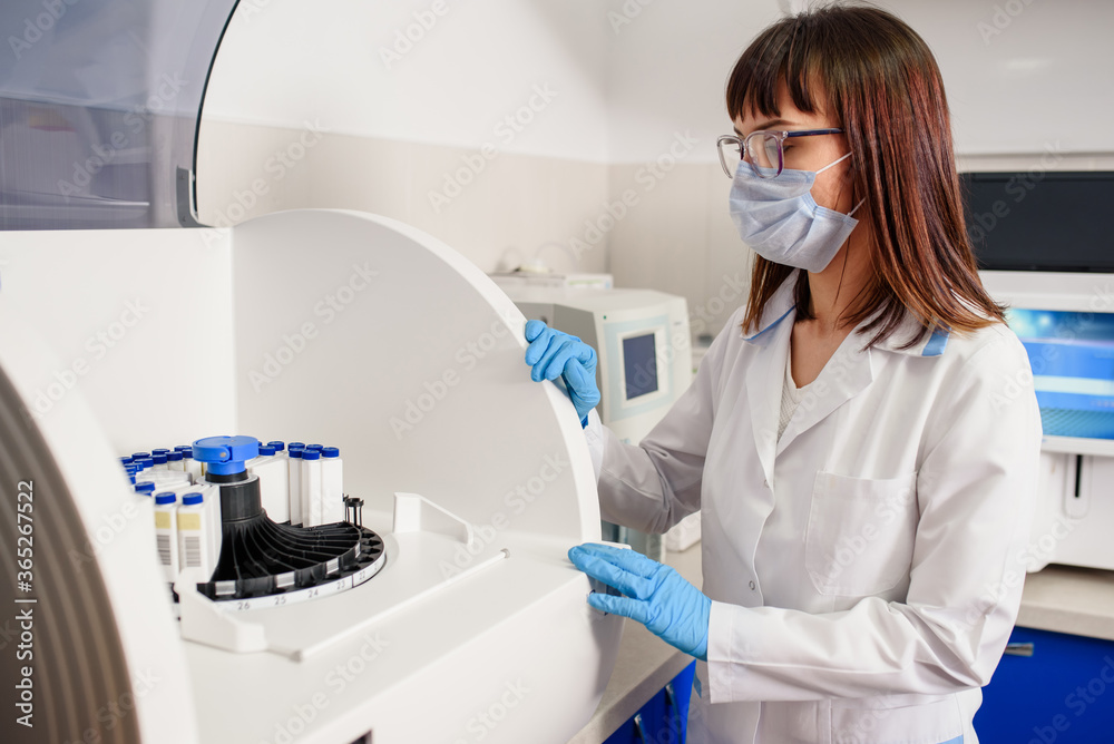 In the hospital laboratory working process, a young woman laboratory ...