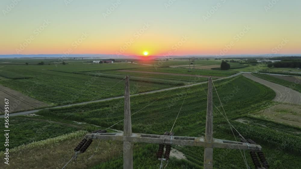 Aerial: power line pylon and telephone wires in rural countryside ...