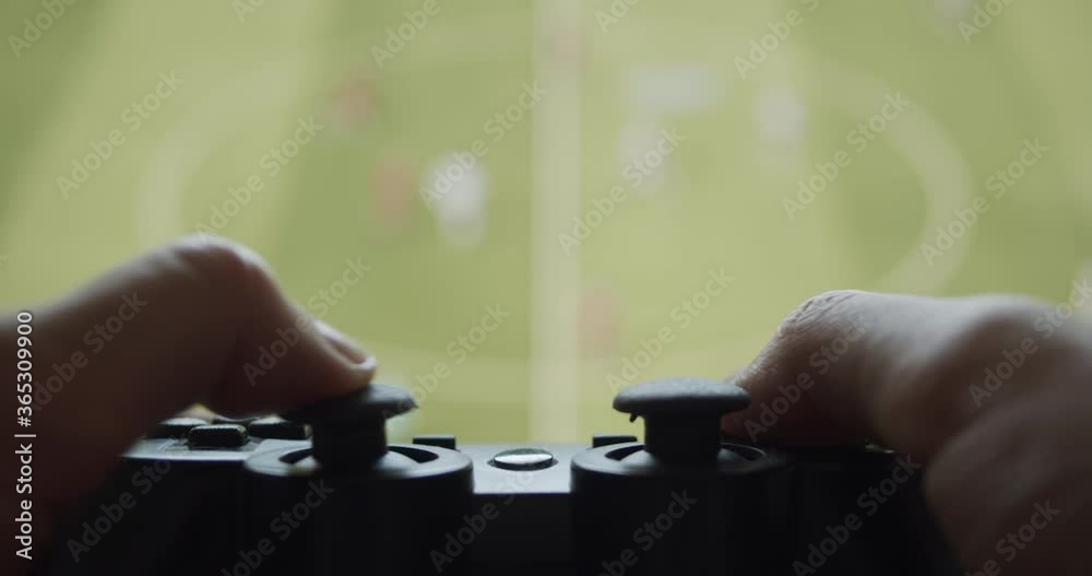 User playing football video game with a joystick controller on a large ...