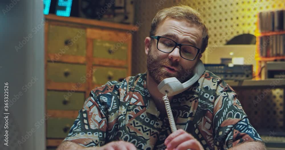 Caucasian young man in glasses sitting at old PC monitor in room of 80 ...