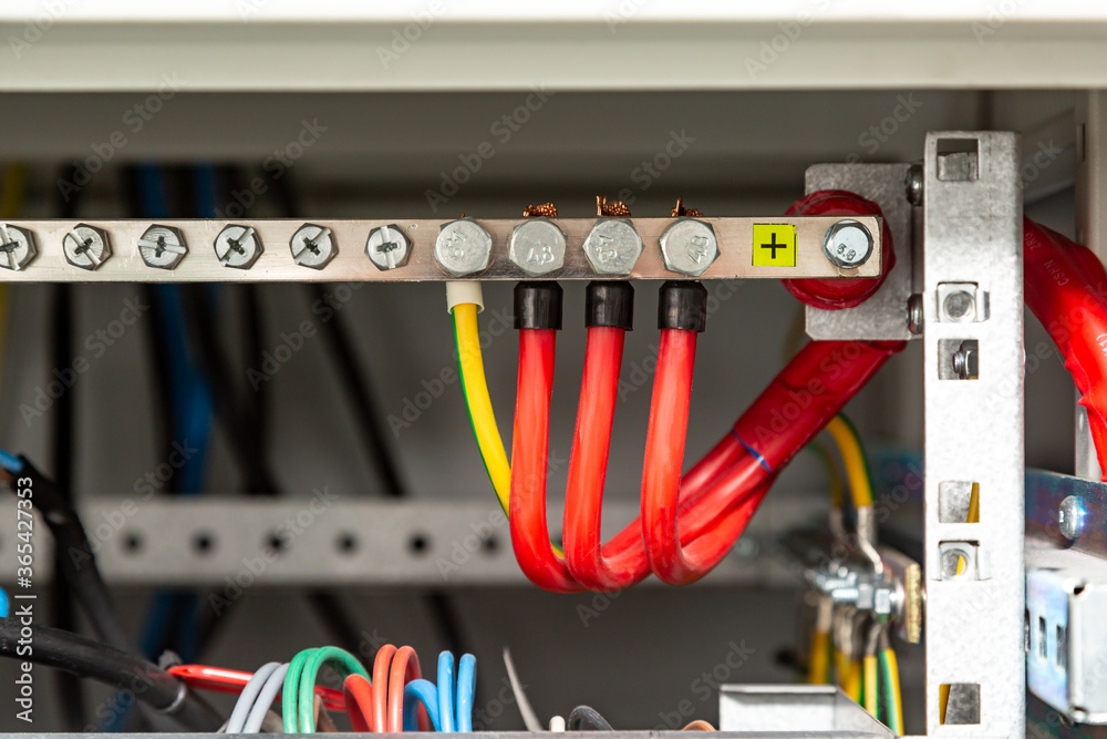 Electrical wires connected to the positive bus plus. Red cables and ...