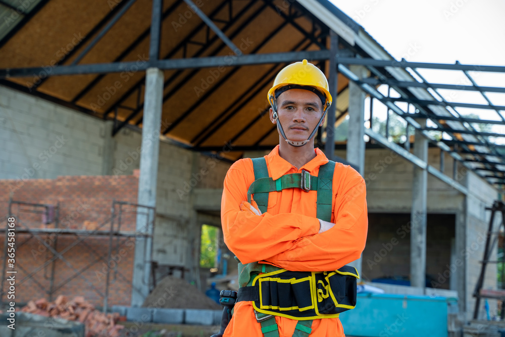 Engineer wearing safety harness and safety line working at high place ...