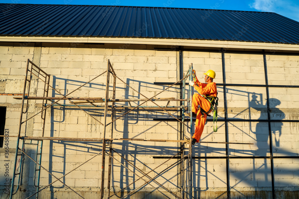 Construction worker wearing safety harness belt during working at high ...