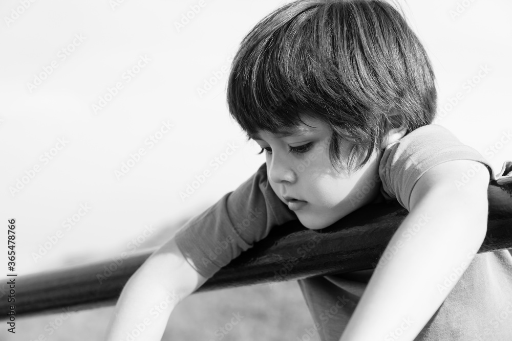 Emotional porrait of lonely child standing alone in playground in black ...