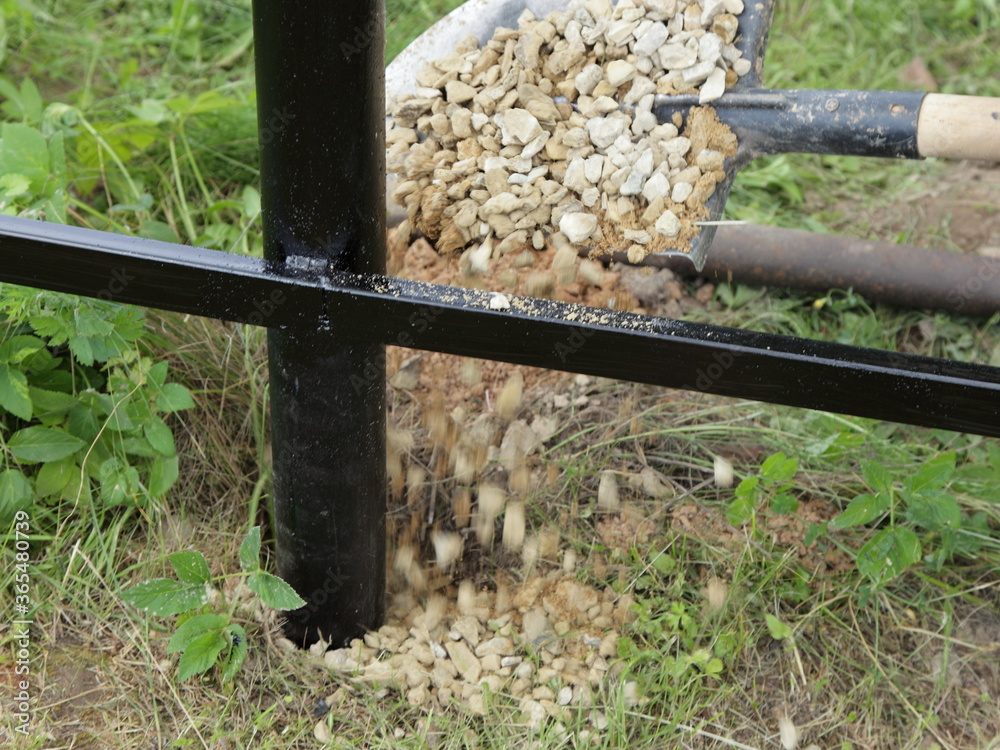 Reinforcement the pillars of the base of the new metal fence with ...