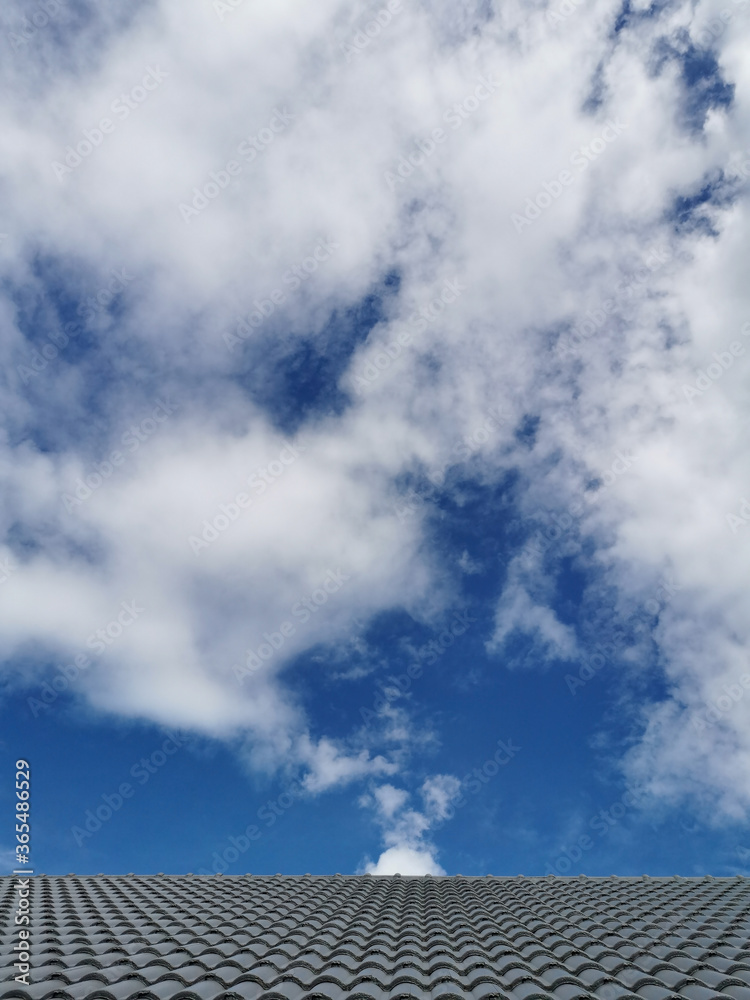 Slate roof against a blue sky, Gray tile roof of construction house ...
